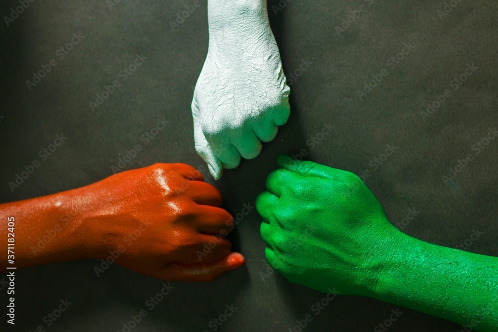 three hands are painted with three colors,saffron,white and green to ...