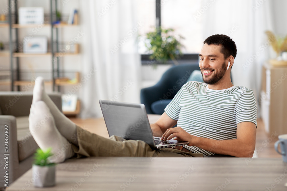 technology, remote job and lifestyle concept - happy smiling man with ...
