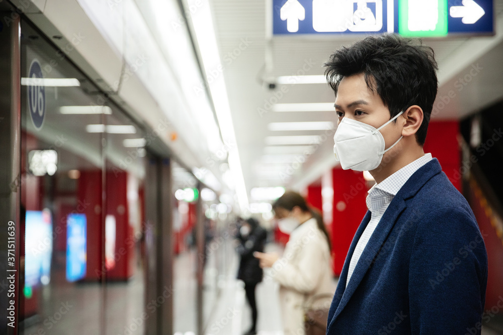 Wearing a mask of the young man standing in the subway platform Stock ...
