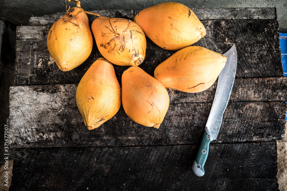 overhead view of king coconut preparation. Rustic authentic chopping ...
