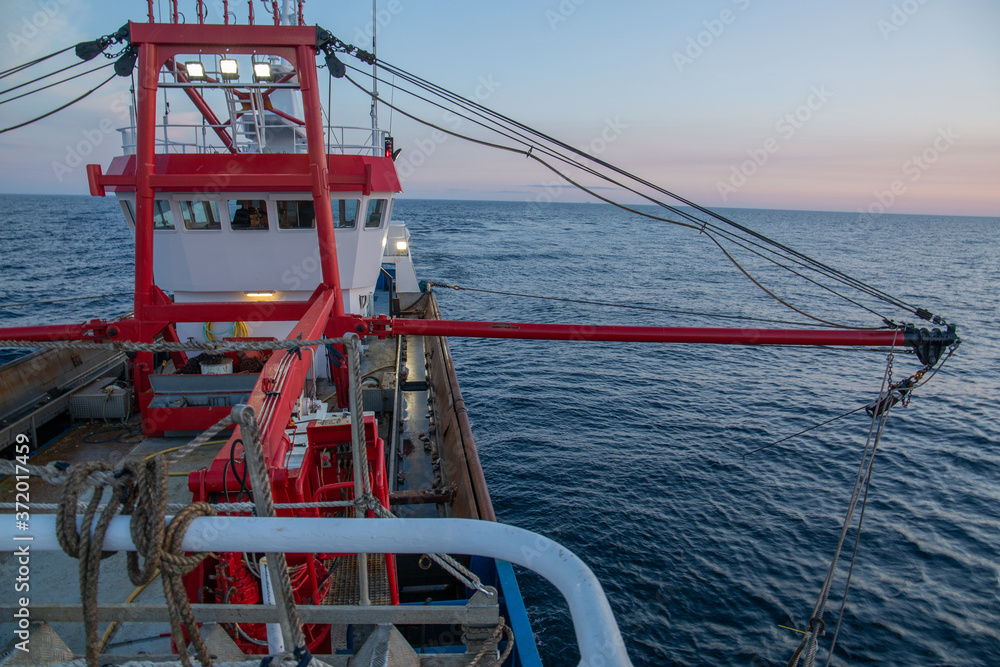 beam trawler fishing vessel with fishing gear deployed trawling for ...
