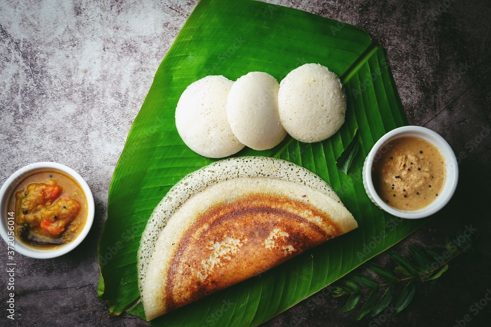 South Indian breakfast Idli Dosa sambar and chutney served in banana ...
