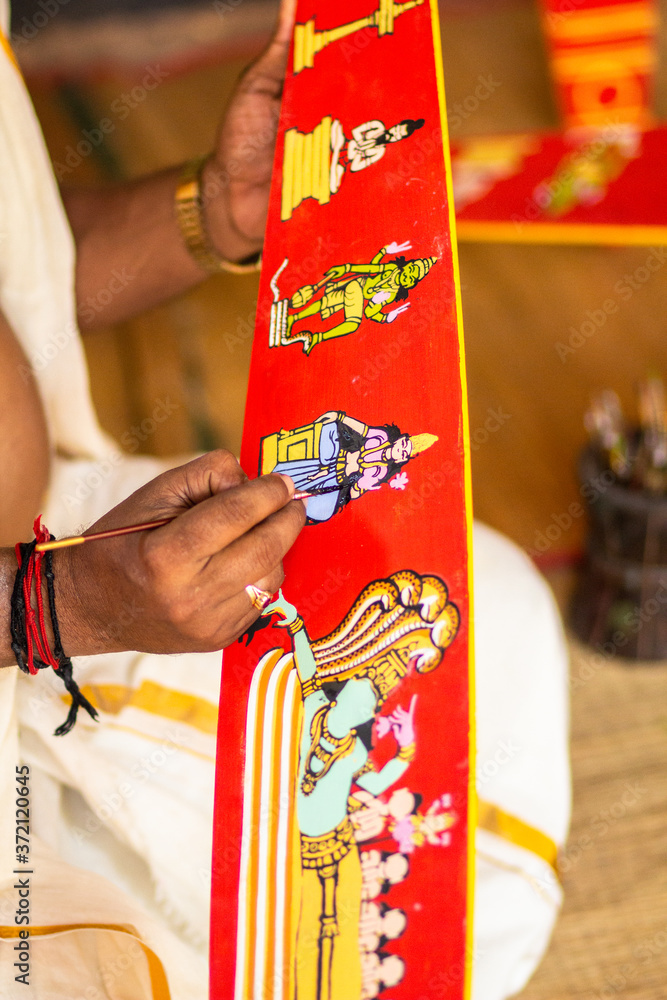 The Ceremonial bow, Onavillu. Artisan painting god's pictures on bow ...