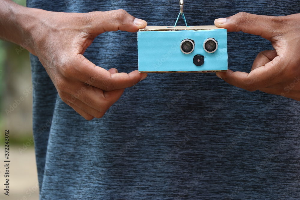 Hand holding Social distance alarm which alerts for safe distance built ...