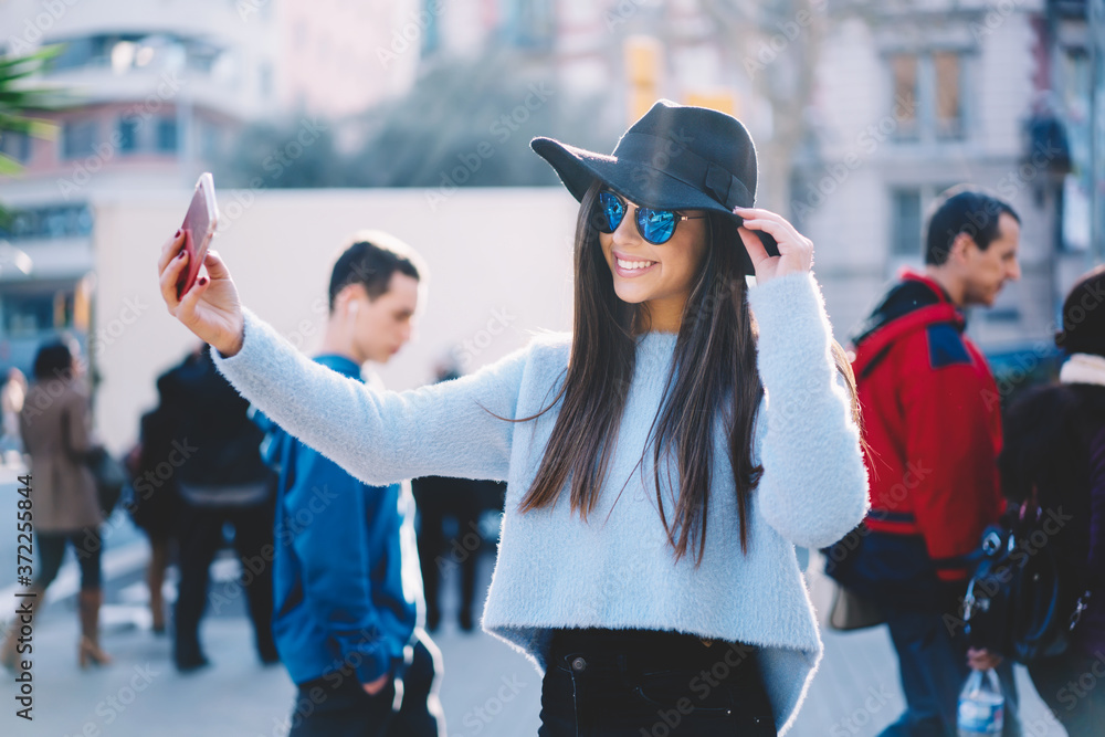 Beautiful cheerful tourist in stylish sunglasses posing while taking ...
