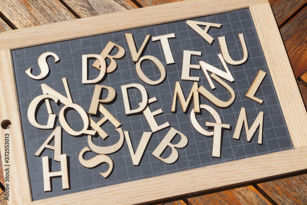 Chalkboard slate and wooden letters for teaching to children how to ...