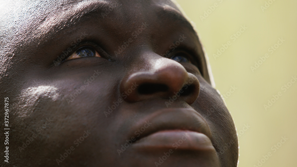 Black lives matter. Close up shot of african man with red eyes looking ...