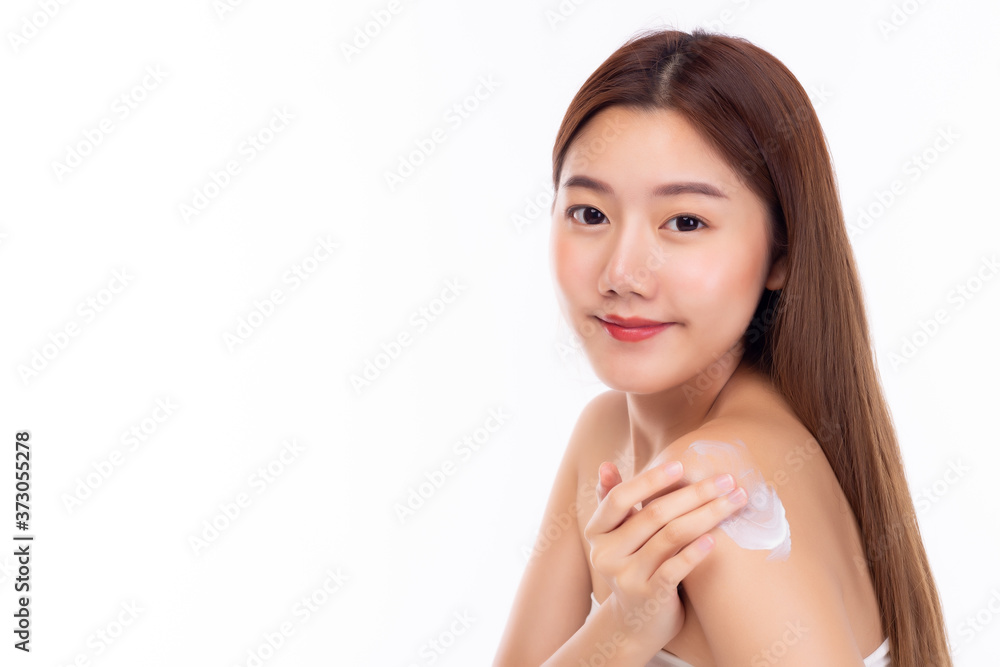 Beautiful asian woman applying body lotion or sunscreen lotion to ...