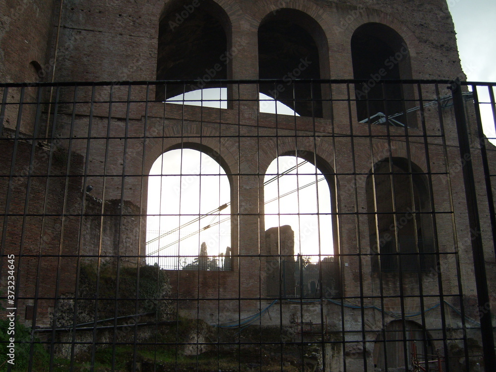 Restoration of the Roman Coliseum. A metal fence around the colosseum ...