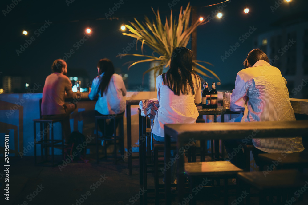 two woman friend relax in night club at terrace and roof top of ...