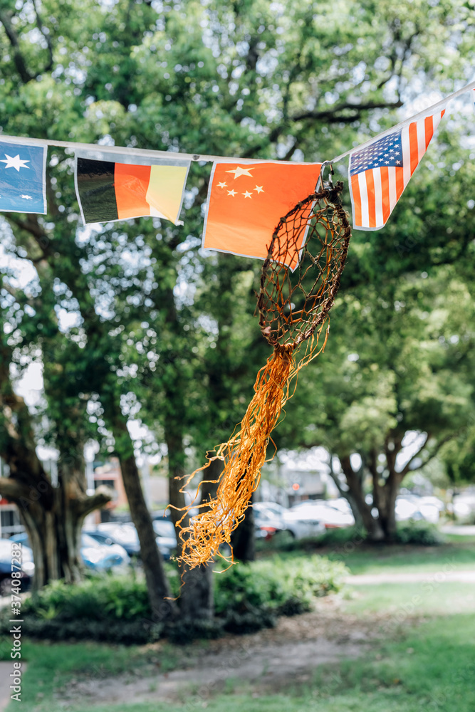 Small flags of different countries stretched on the tree. Multicultural ...