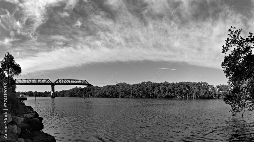 Beautiful black and white panoramic view of a river with tall ...