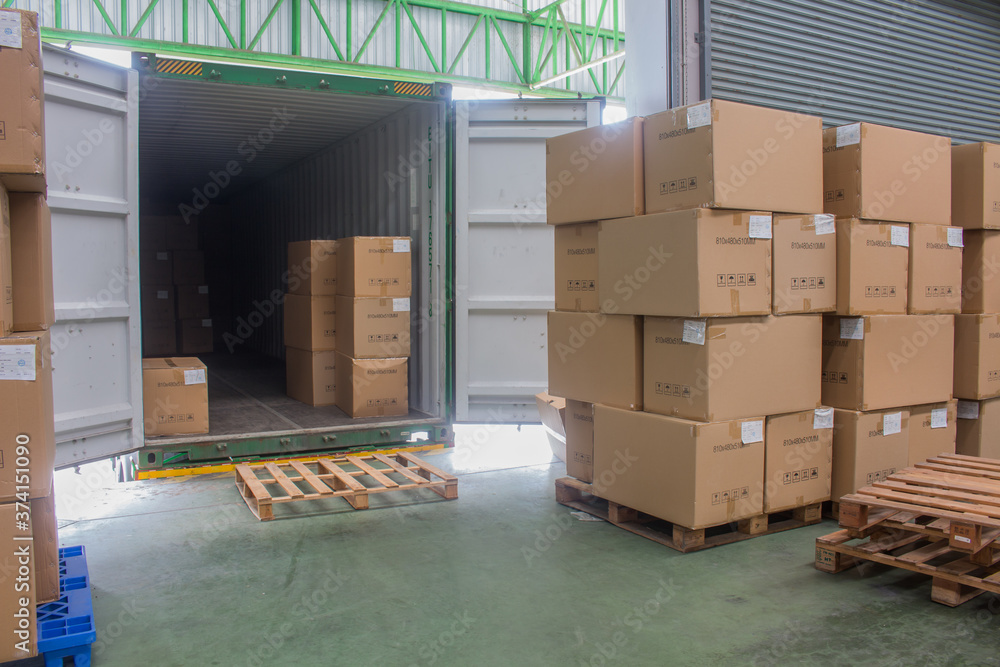 loading shipment carton boxes and goods on wooden pallet at loading ...