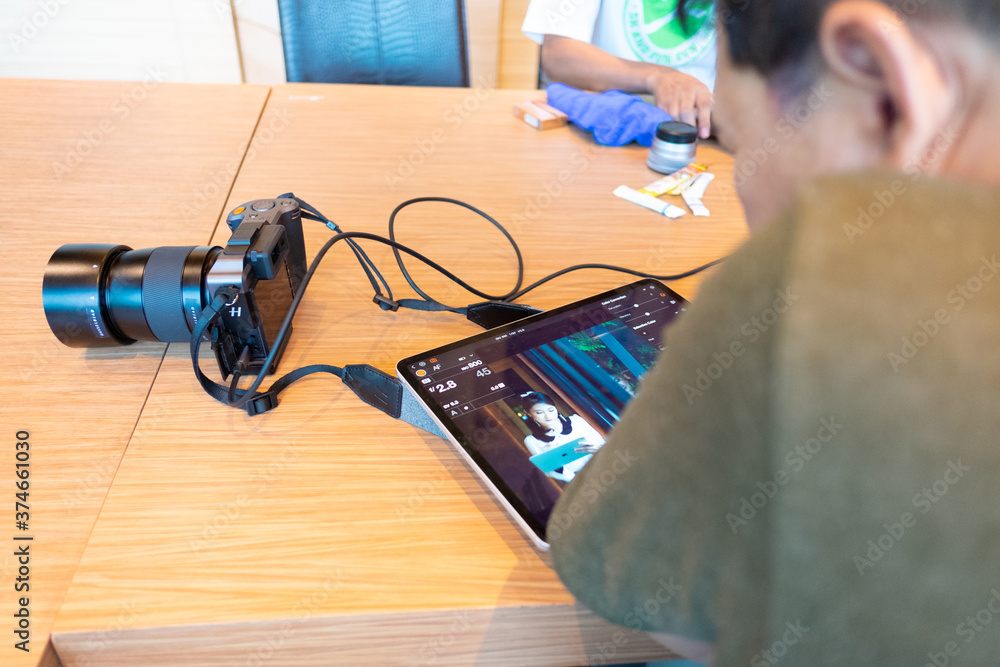 Transfer photos from camera to tablet via cable. Unmarked camera Stock ...