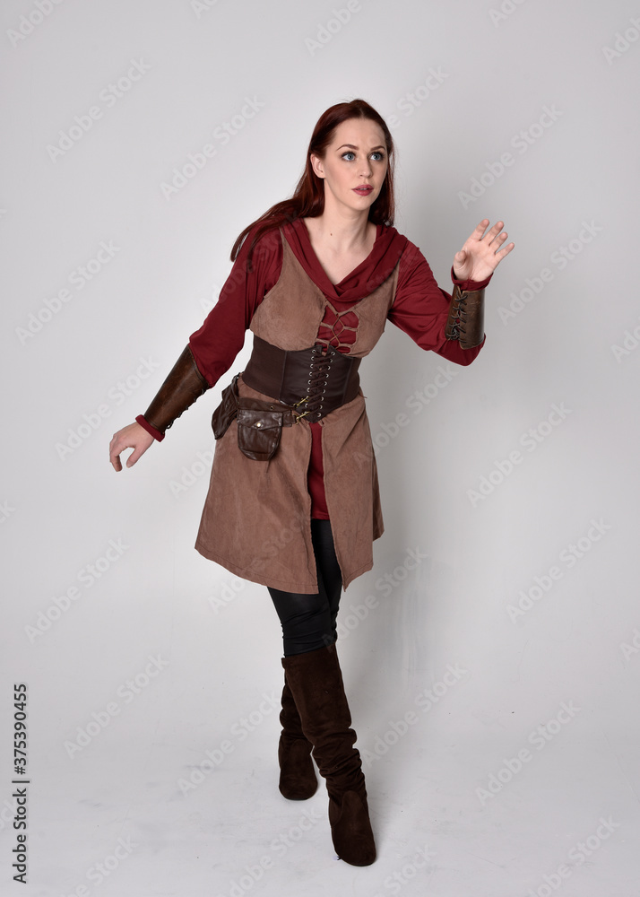 Full length portrait of girl wearing medieval costume. Standing pose ...