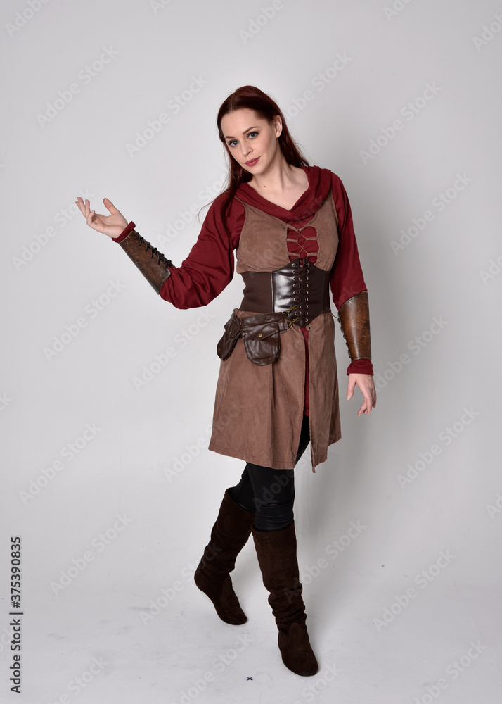 Full length portrait of girl wearing medieval costume. Standing pose ...