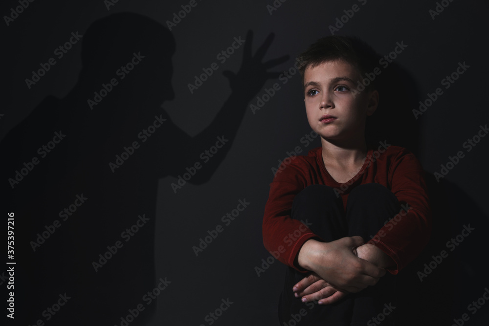 Child abuse. Father yelling at his son. Shadow of man on wall Stock ...