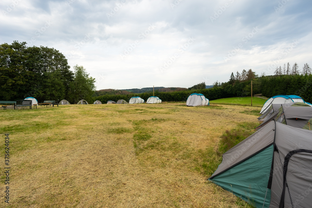 Scout camping. Army military tent close up in the base camp. Lots of ...