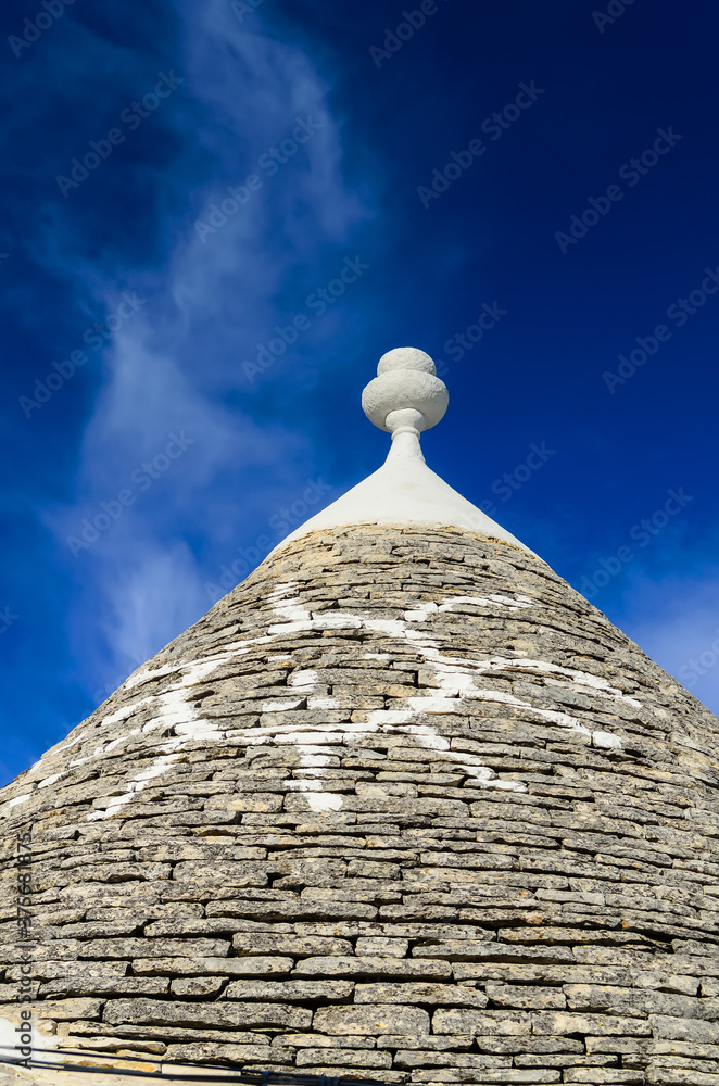 Conical roofs of trulli in Alberobello.. Each trullo is decorated with ...