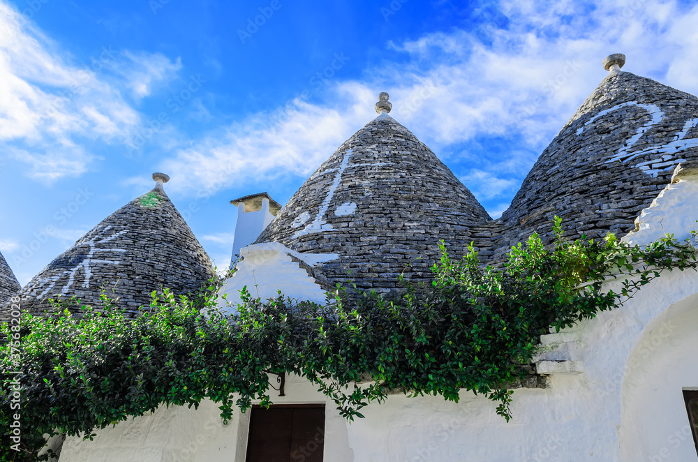 Conical roofs of trulli in Alberobello.. Each trullo is decorated with ...