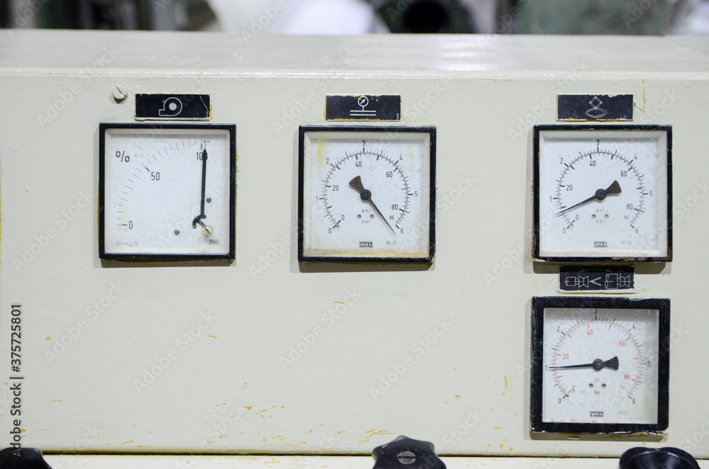Machine operating console in factory. Old control panel on production line. Many buttons ...