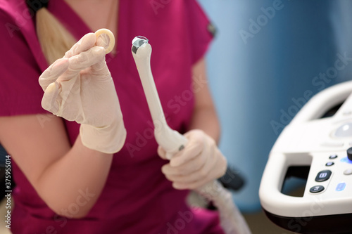 Gynecologist places ultrasound probe cover on a transvaginal ultrasound ...