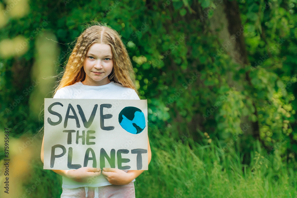 child girl activist with save the planet poster in forest park. preteen ...