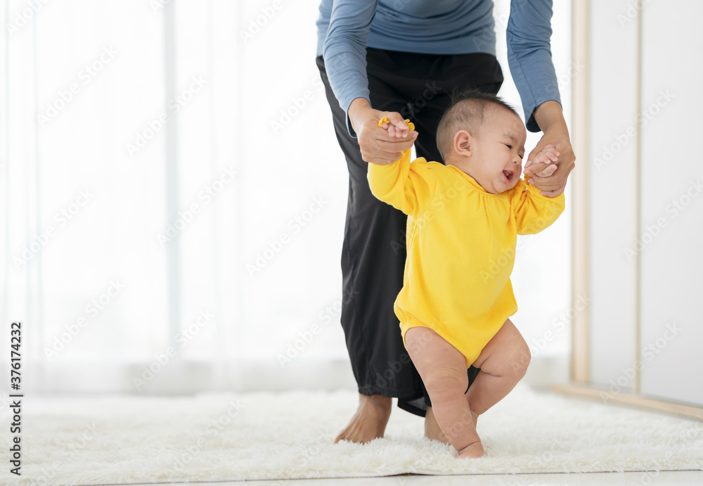 My little girl takes first steps. family happy little baby learning to ...