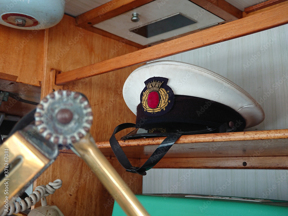 A captain's hat on the side of the shelf in the cockpit of a submarine ...