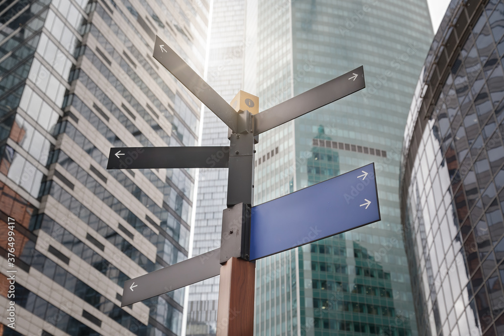 Signpost with street direction mock up in the city downtown, blank sign ...