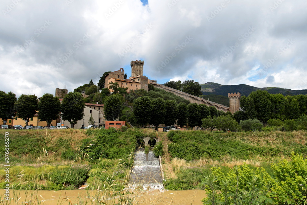 Vicopisano Castle and its medieval village with the stream that passes ...