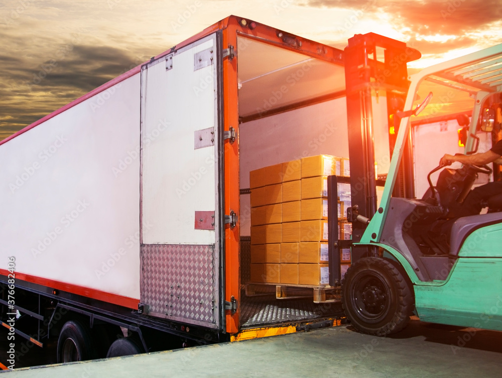 Forklift Tractor Loading Packaging Boxes into Cargo Container. Cargo ...