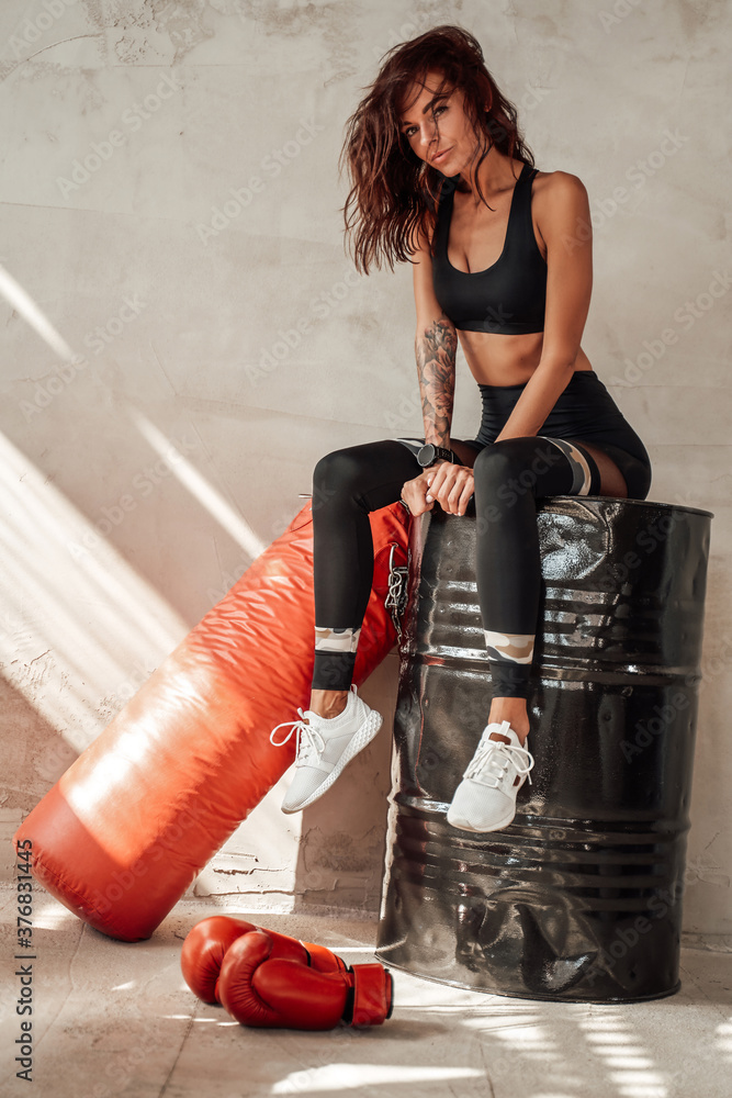 Special sports items and female lean boxer which sitting on black ...