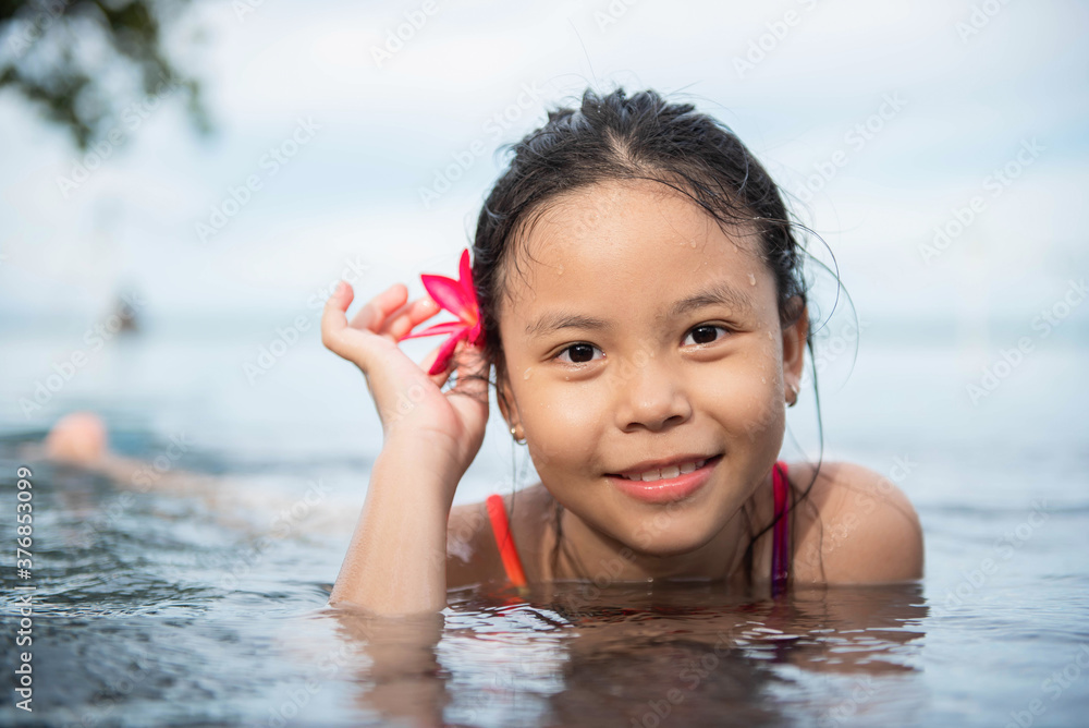 little girl playing in outdoor swimming pool in water on summer ...