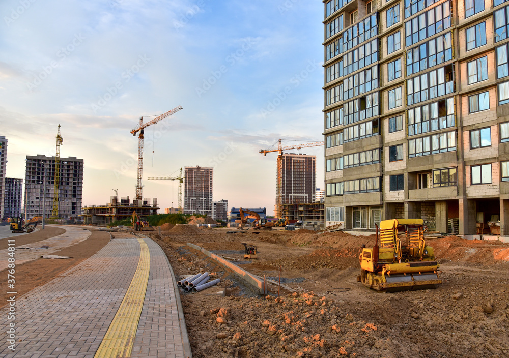Vibro Roller Soil Compactor leveling ground at construction site. Tower ...
