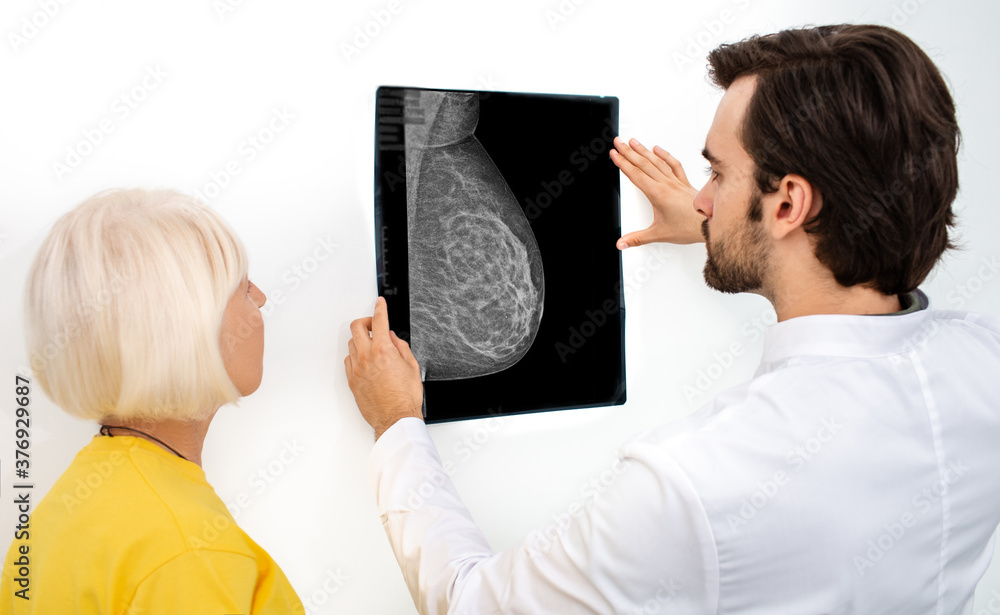 Mammogram film image of a female breast. Oncologist and an elderly ...