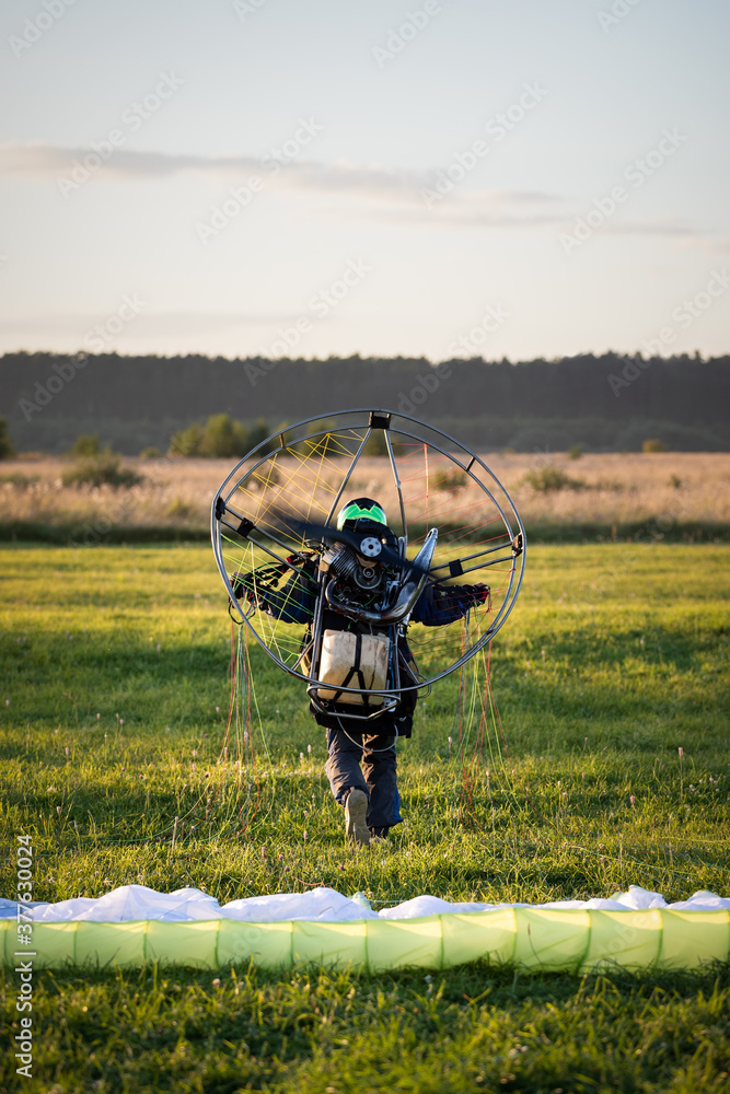 View from the back of the pilot running across the field with an ...
