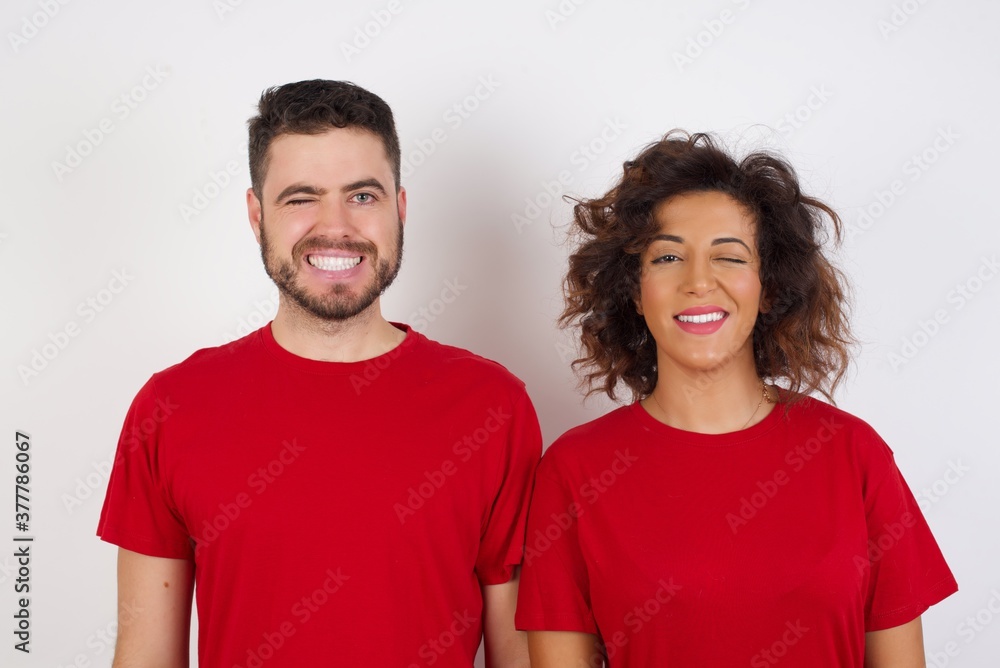 Coquettish Young beautiful couple wearing red t-shirt on white ...