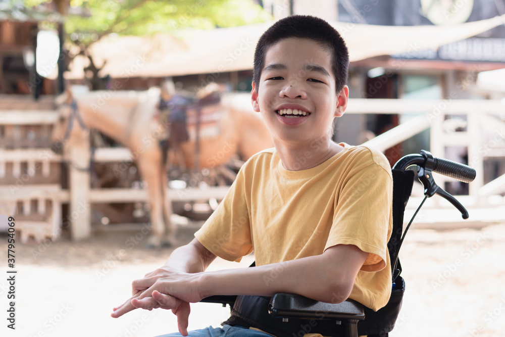 Disabled child on wheelchair is playing,learning and exercise in the ...
