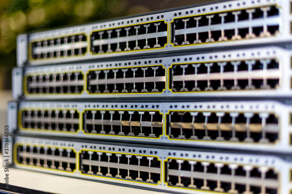 A stack of network switches with empty ports exposed just removed from ...