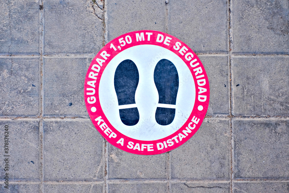 Fotografie Covid-19 safe distance sign in Spanish and English (Spanish ...