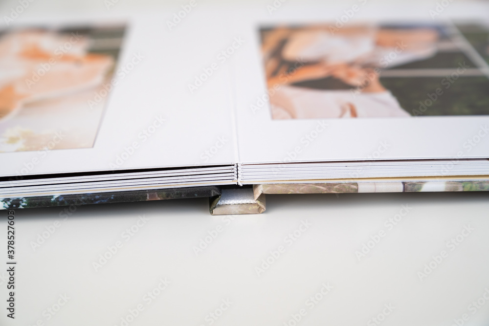 close up. photo book binding. storing photos from a photo session in a ...