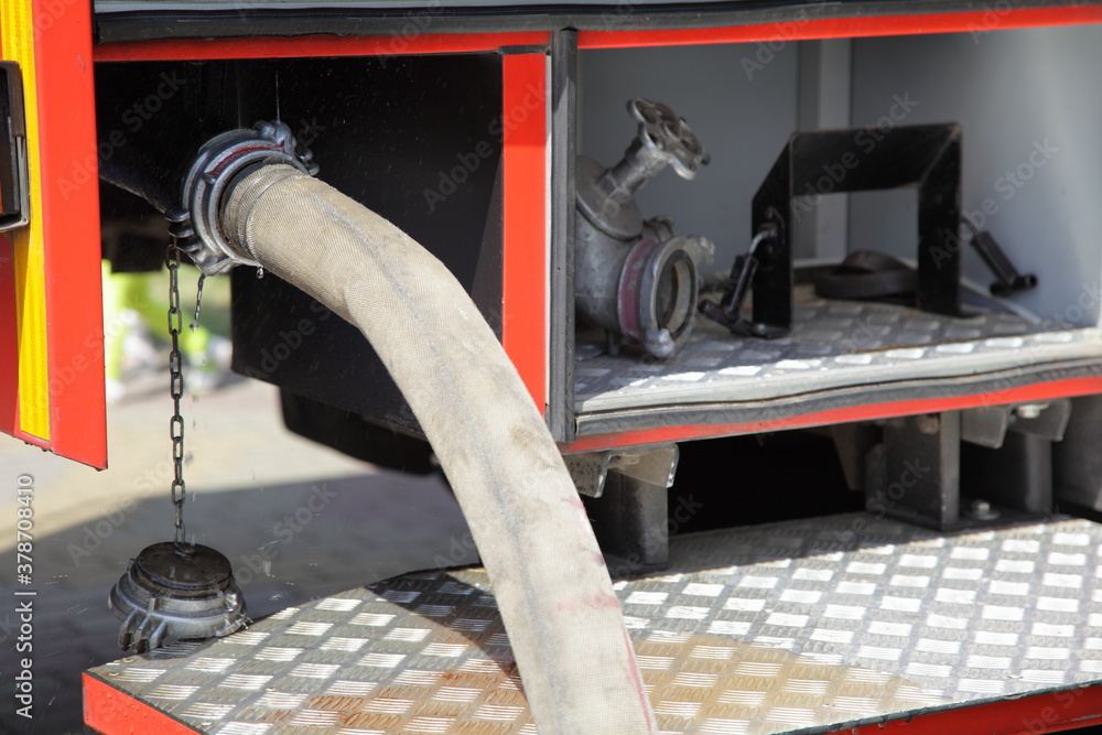 Fire hose close up on modern red fire truck motor pump, firefighter ...