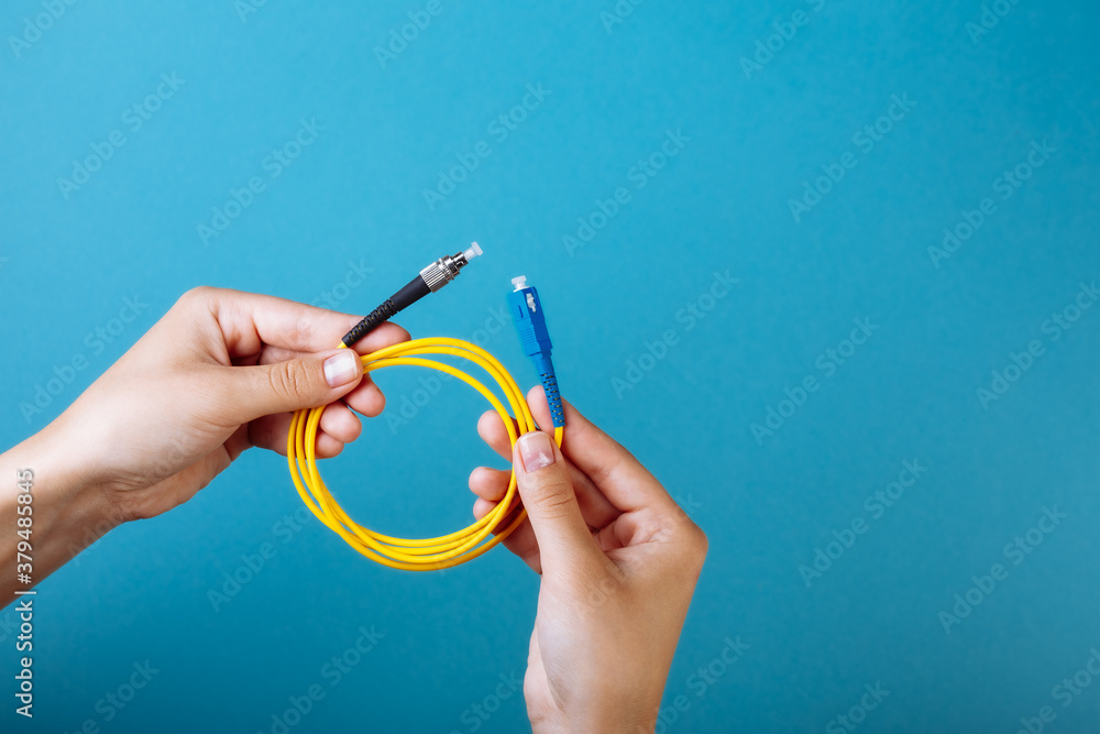 woman's hands hold SC and FC connector fiber optic patch cord single ...