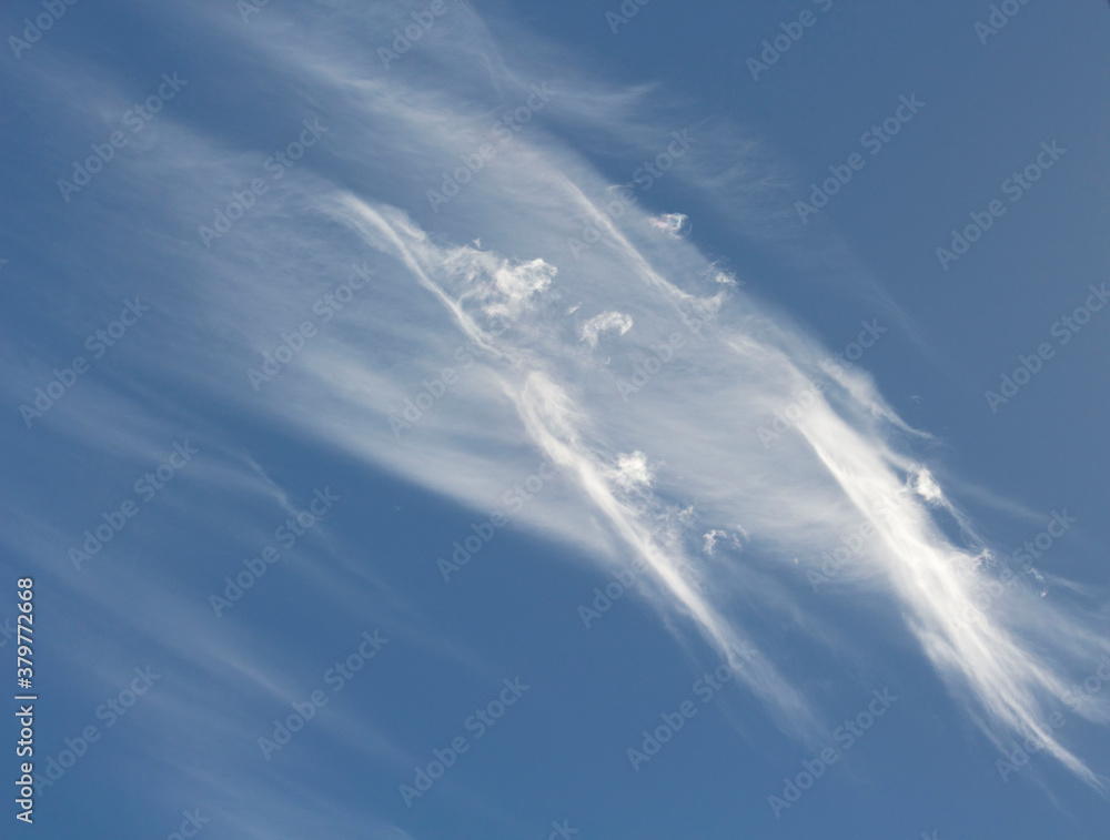 High white wispy cirrus clouds with cirro-stratus in the blue ...