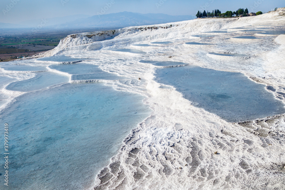 Snow white travertine terraces of Pamukkale, Turkey. Pools filled with ...
