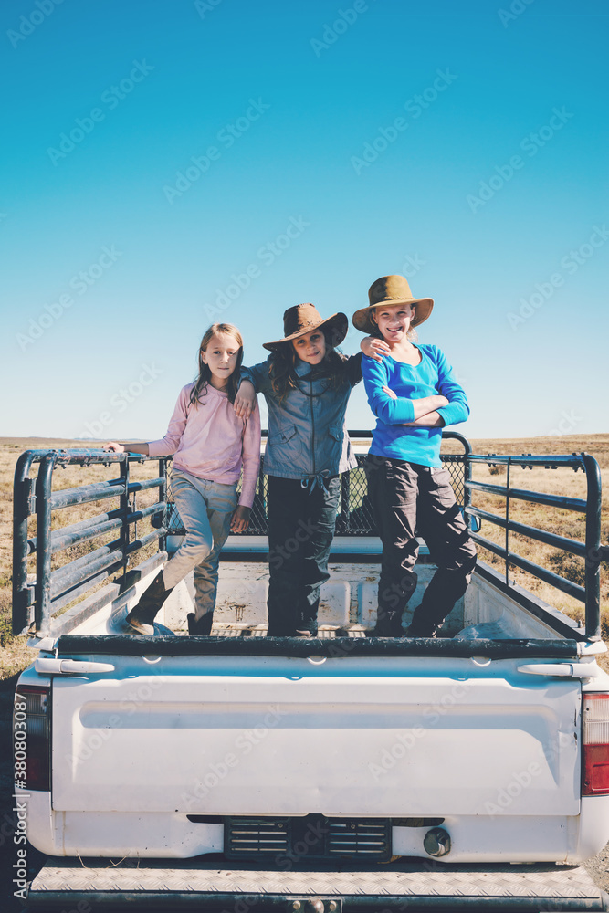 three sisters in the back of a ute on a farm in the Karoo, South Africa ...