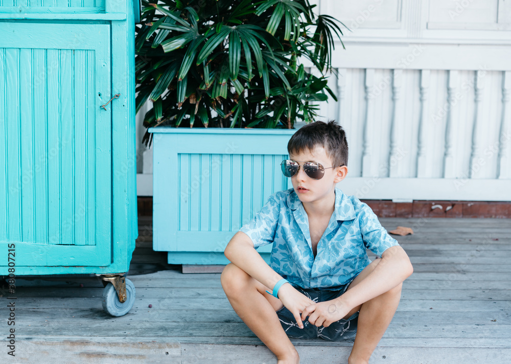 8 years old kid sitting alone on a veranda Stock Photo | Adobe Stock