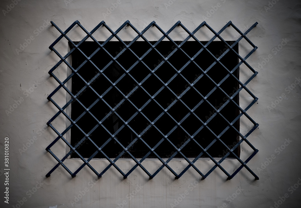 Barred prison cell window, dark and depressive. Stock Photo | Adobe Stock