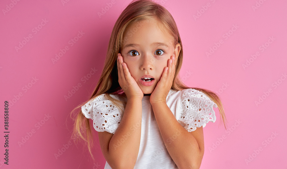 portrait of little caucasian girl in shock, she is surprised by ...